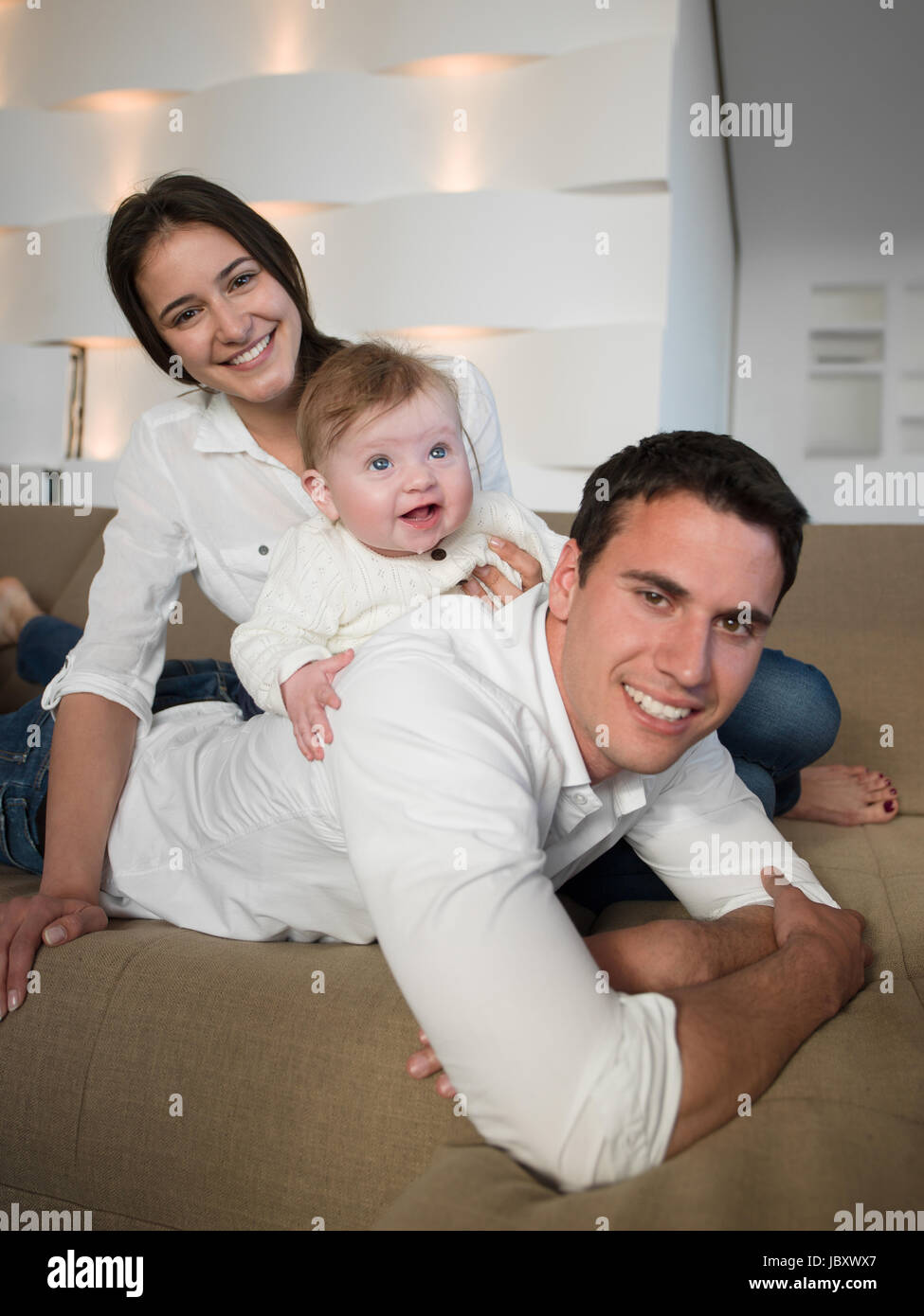 happy young family couple with beautiful new born baby have fun at ...