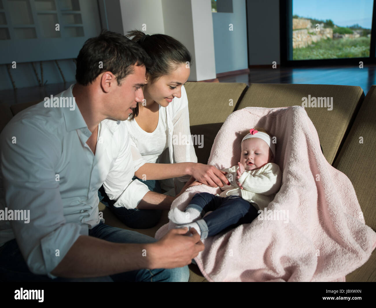 happy young family couple with beautiful new born baby have fun at ...