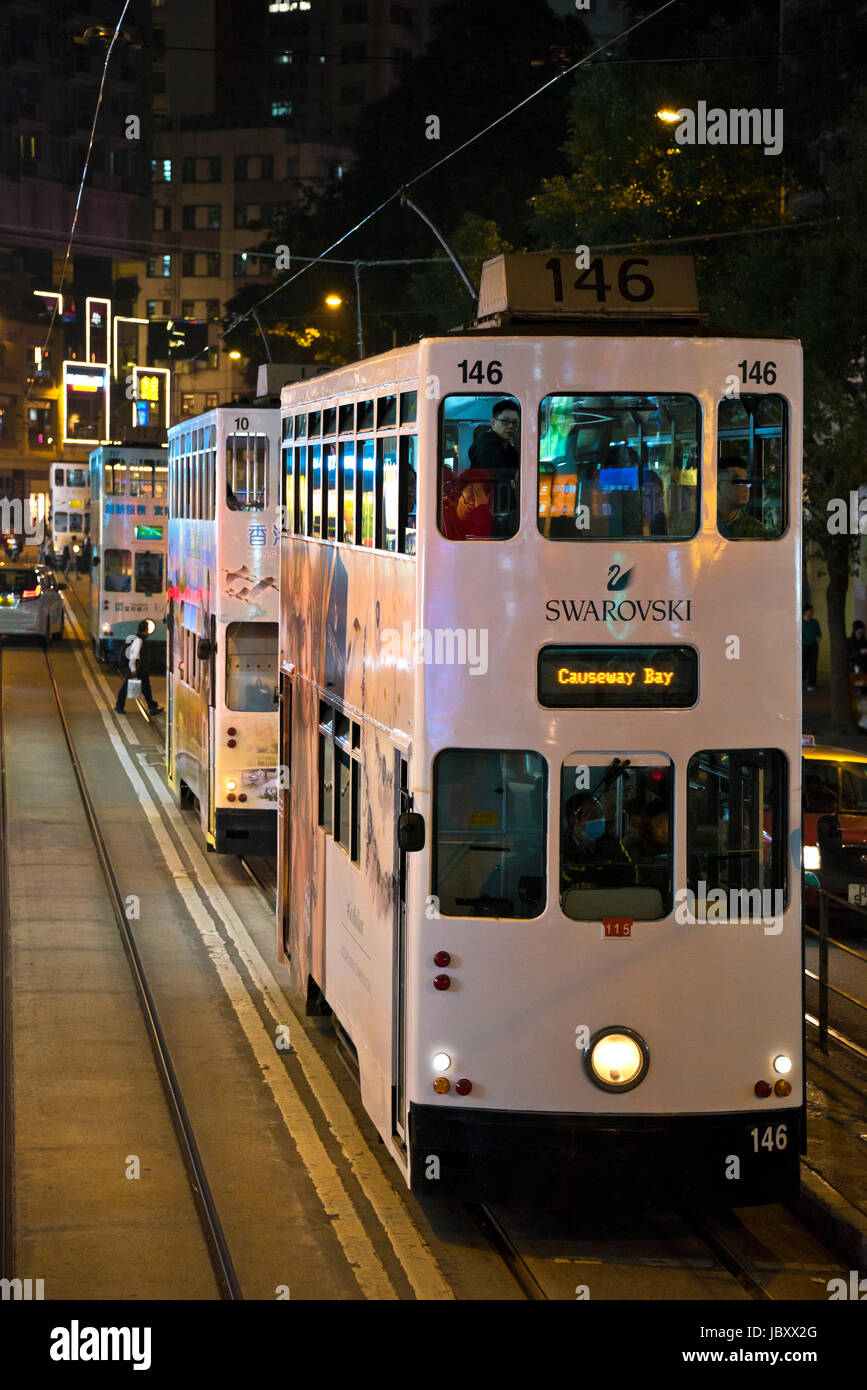 Vertical view of the traditional old trams at night in Hong Kong, China ...