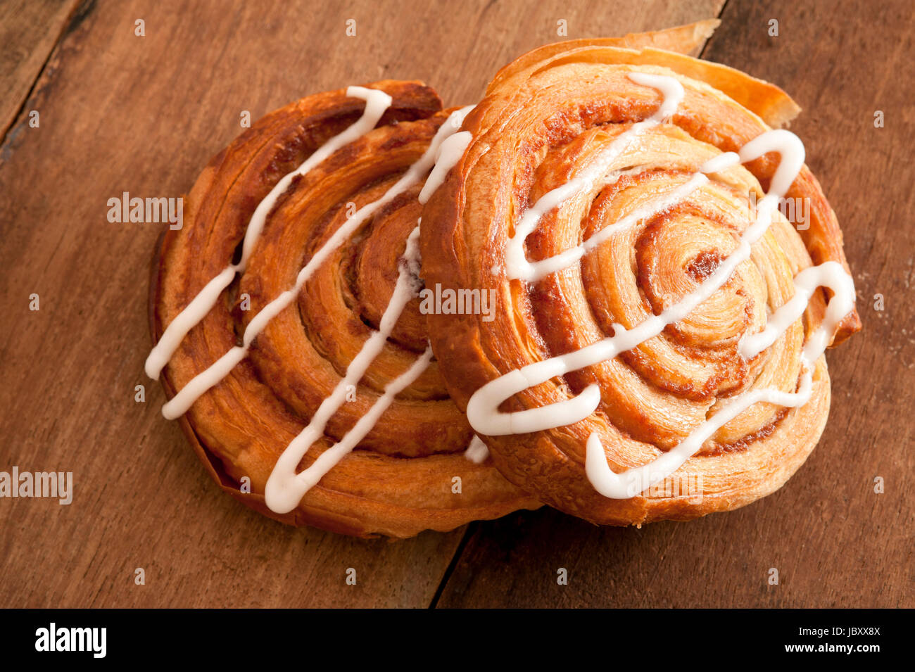 Freshly baked spiral Danish pastries with flaky puff pastry filled with ...