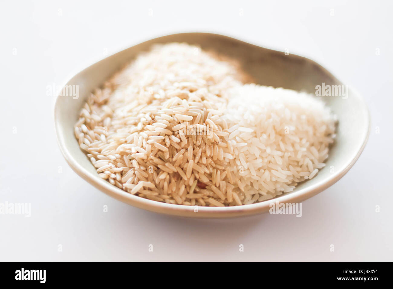 A mound of natural brown and white rice seeds Stock Photo - Alamy