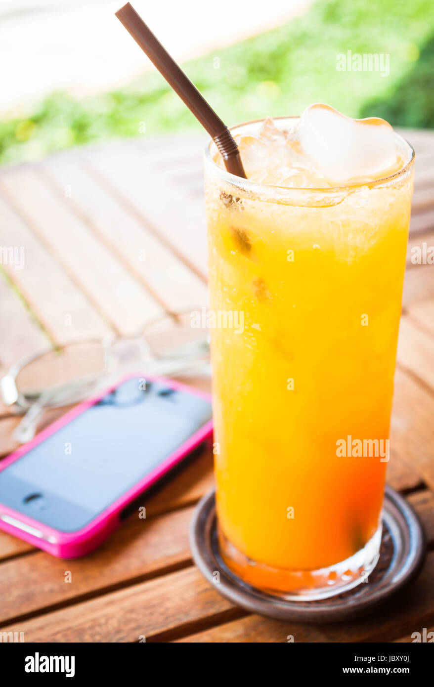 Summer fresh time with orange juice and straw Stock Photo - Alamy