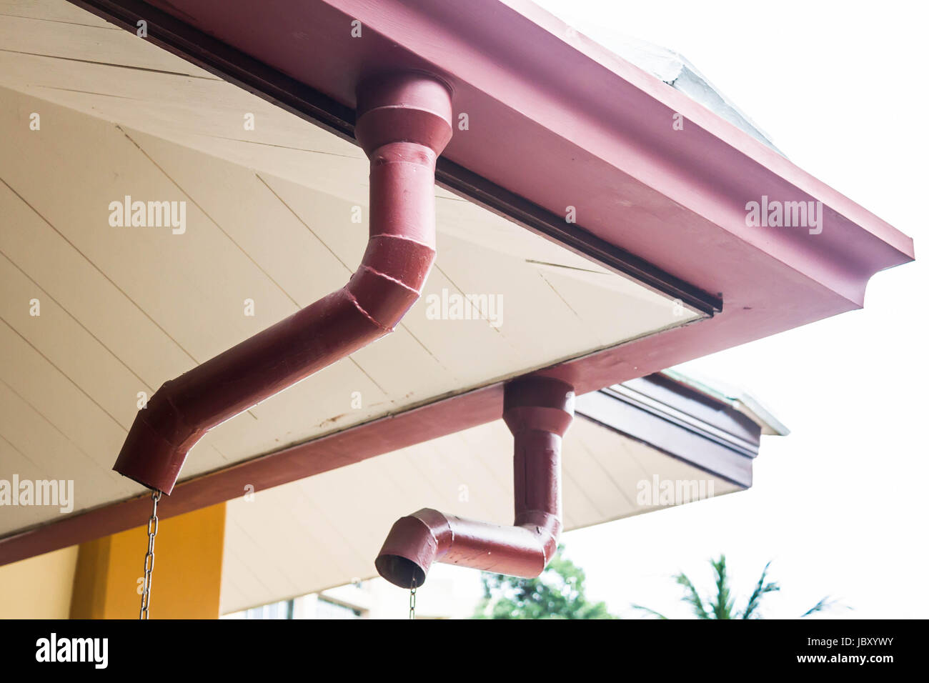Corner of house with rain gutters on sky background Stock Photo - Alamy
