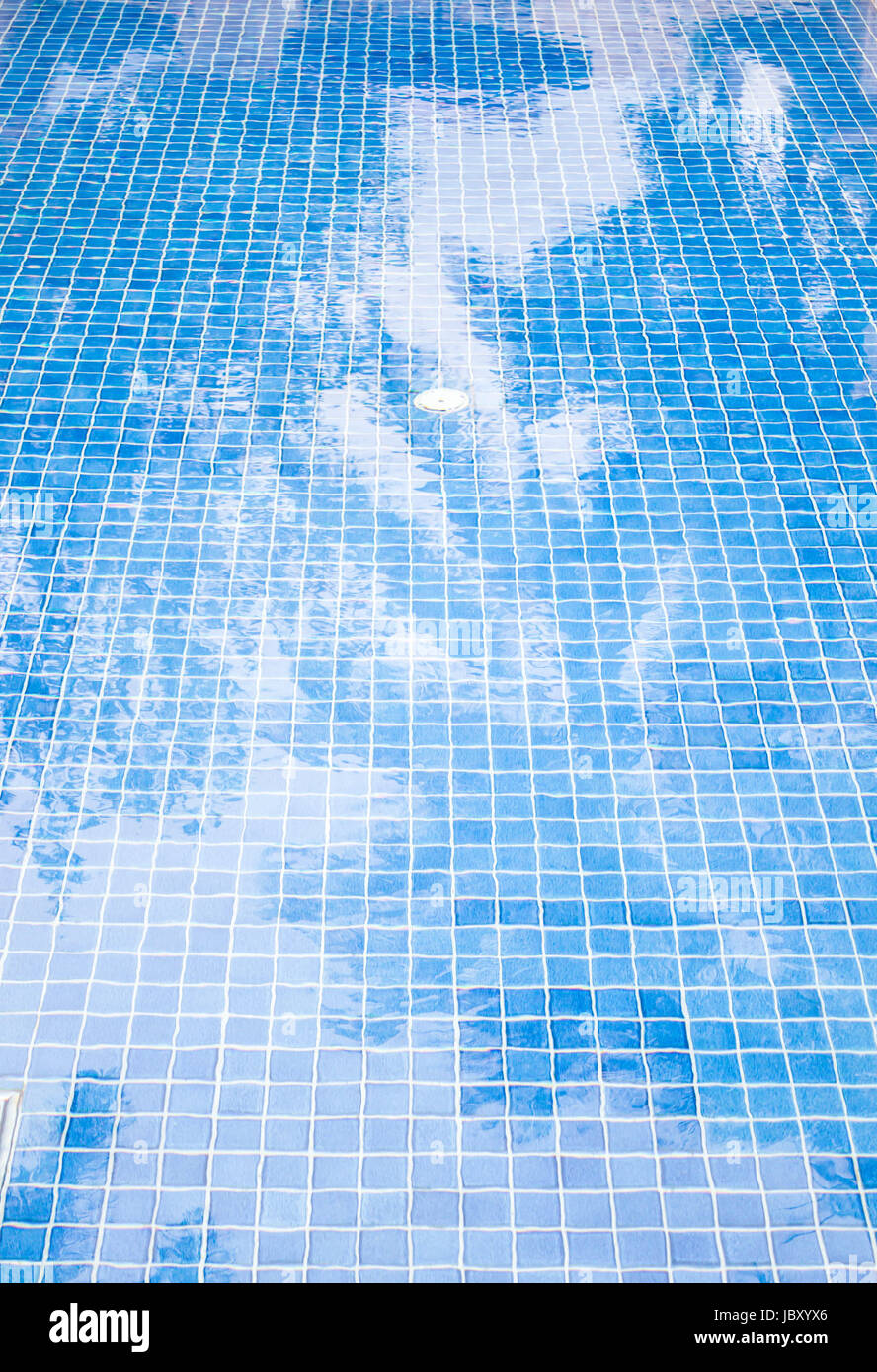 Swimming pool with coconut shade reflection on water Stock Photo - Alamy