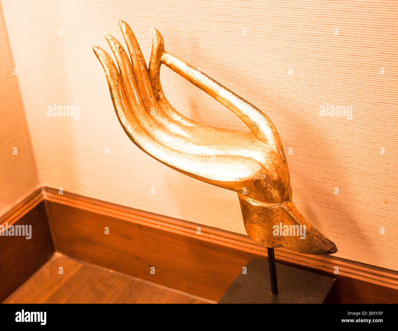 Gold wood carved hand sculpture on wood table Stock Photo - Alamy