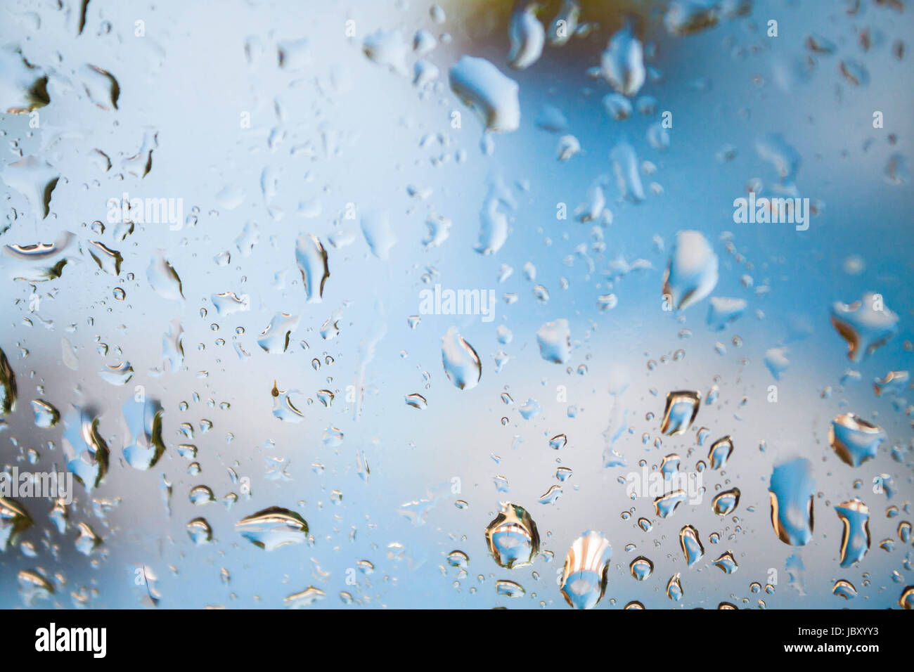 Behind the mirror of rain drops background Stock Photo - Alamy