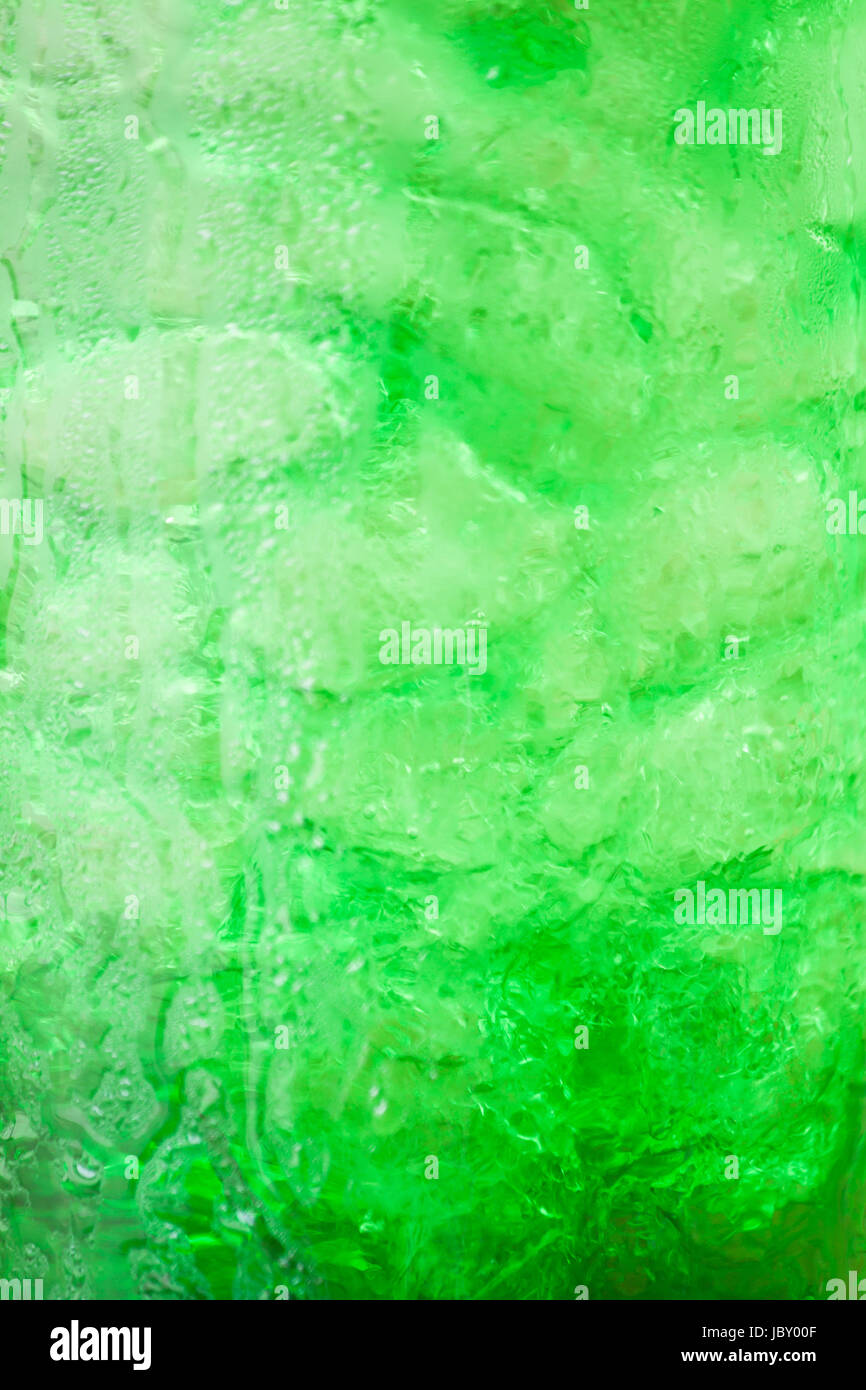 Green fizzy drink with ice cubes background Stock Photo - Alamy