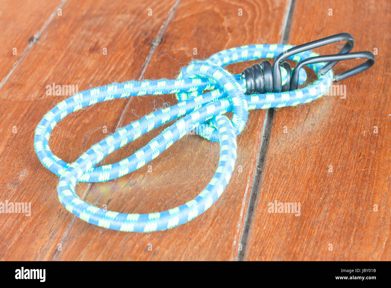 Light blue elastic rope on wood background Stock Photo - Alamy