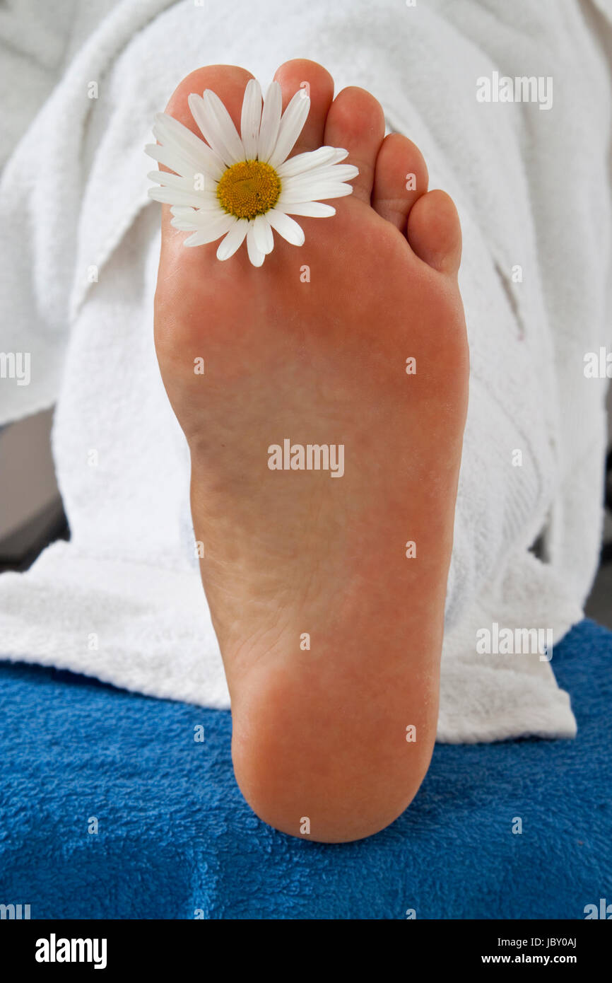 Foot with flower on white background Stock Photo - Alamy