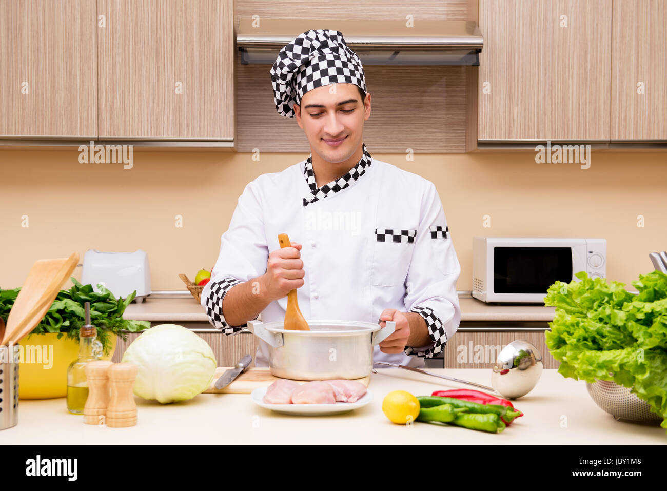 Young chef working in the kitchen Stock Photo - Alamy