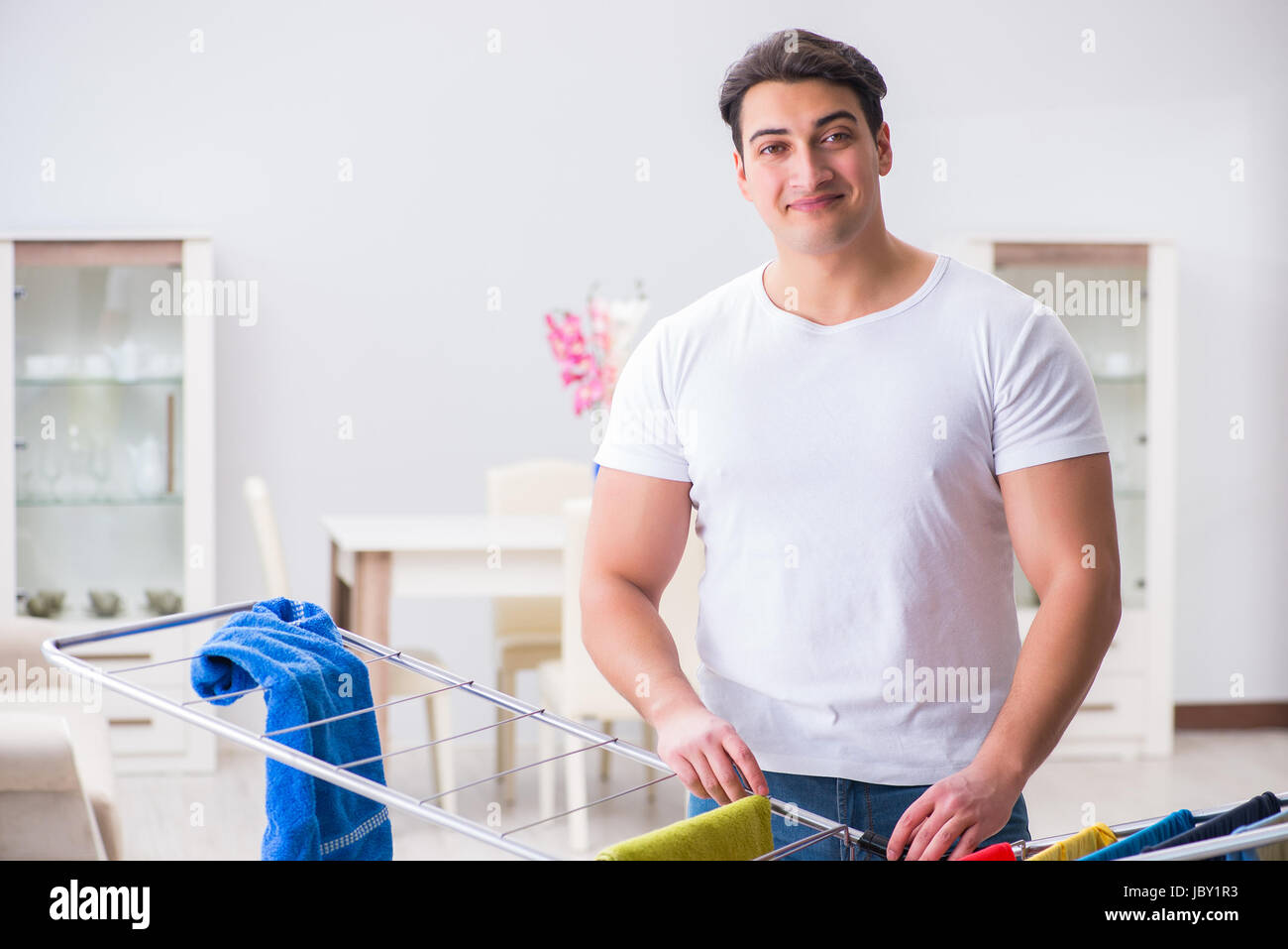 Man doing laundry at home Stock Photo - Alamy