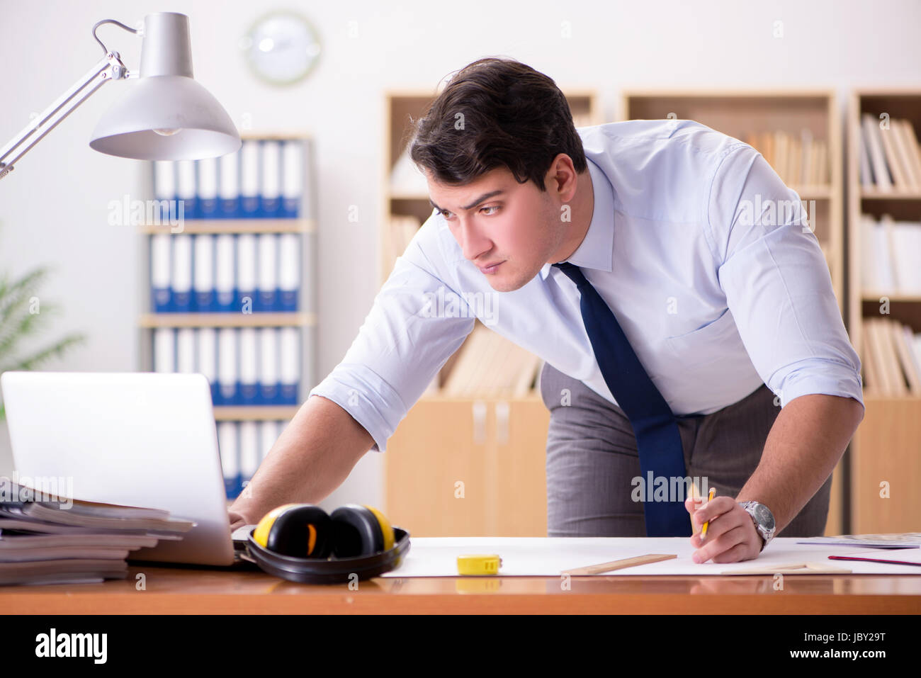 Engineer supervisor working on drawings in the office Stock Photo - Alamy