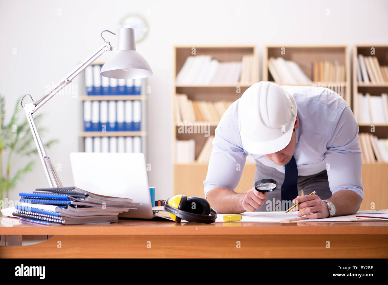 Engineer supervisor working on drawings in the office Stock Photo - Alamy