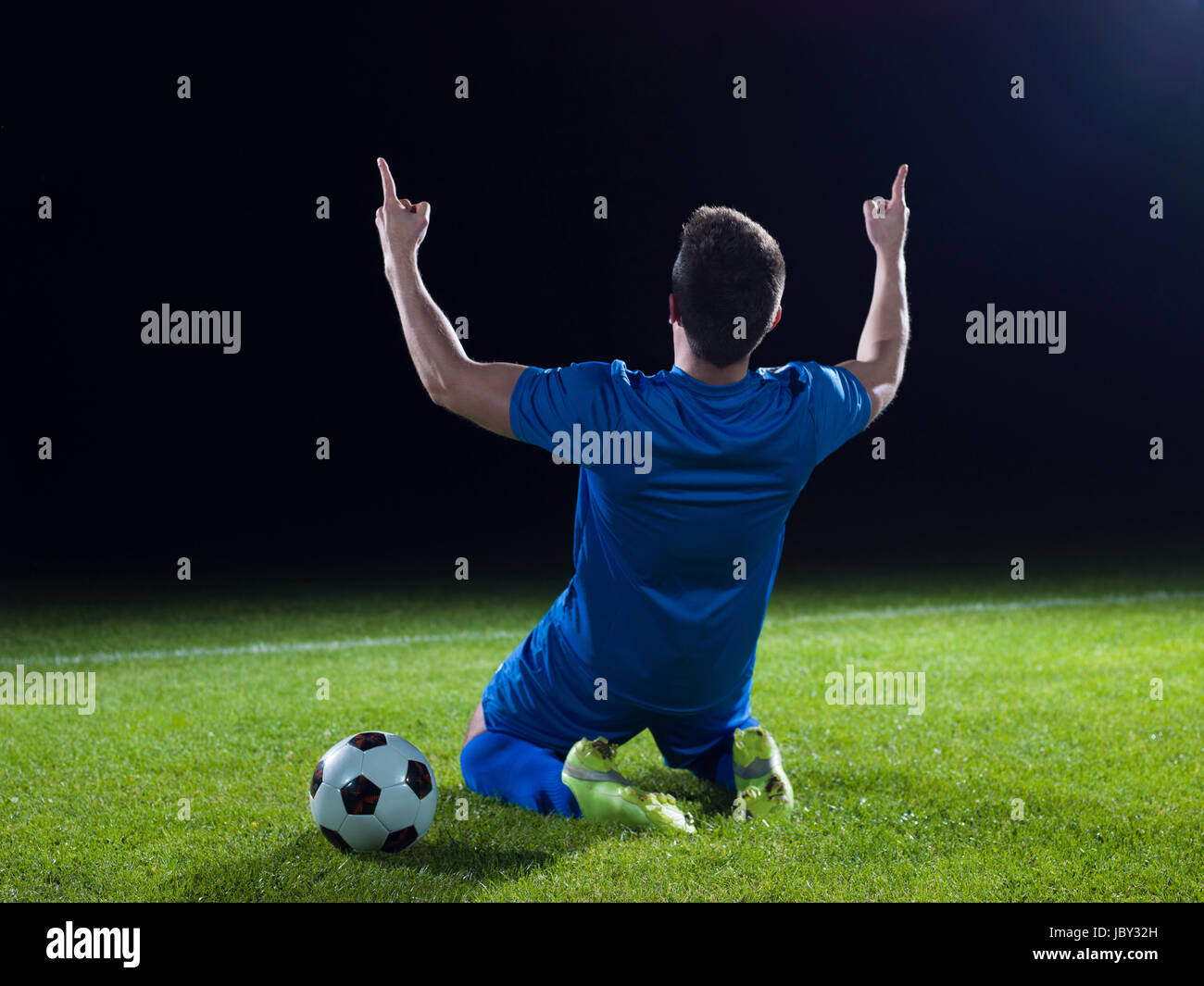 soccer player doing kick with ball on football stadium field isolated ...