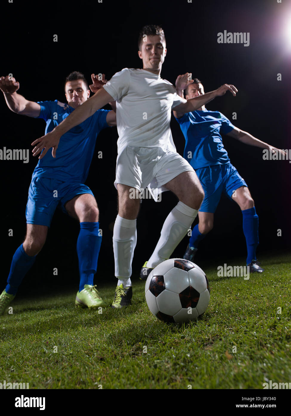 soccer player doing kick with ball on football stadium field isolated ...