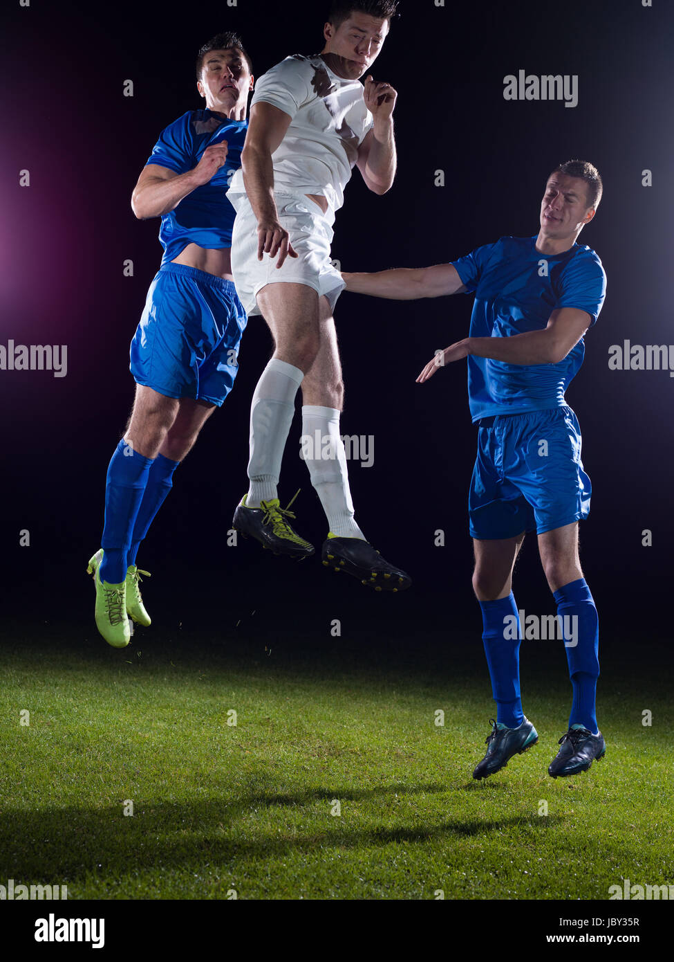 soccer player doing kick with ball on football stadium field isolated ...