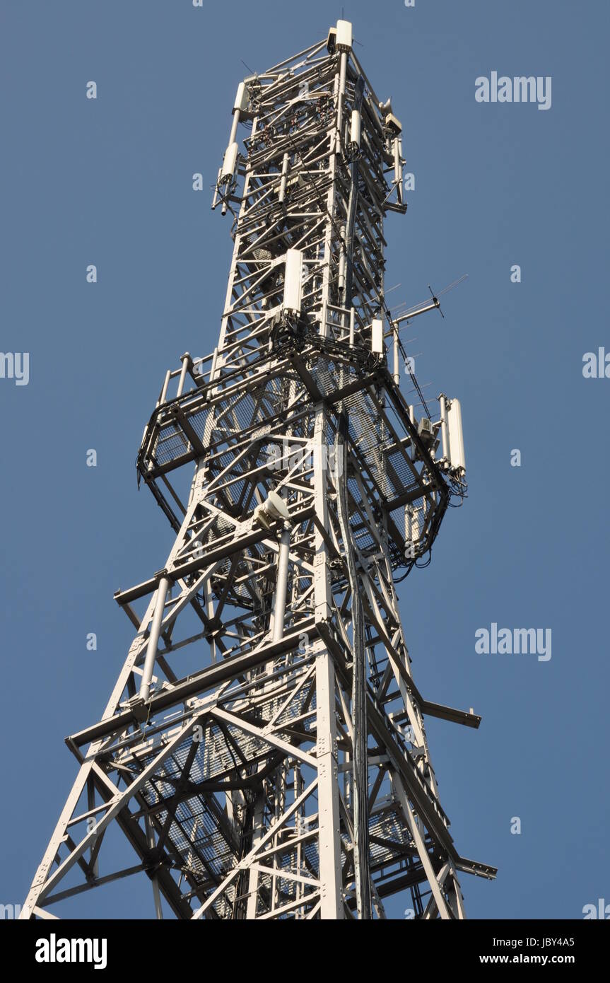 Telecommunication towers with antennas on clear blue sky Stock Photo ...