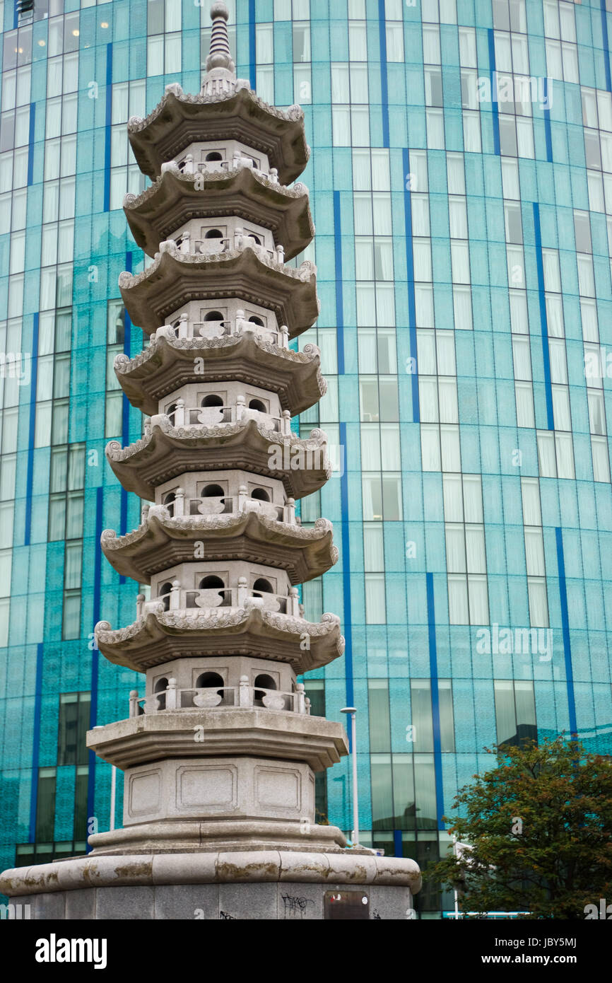 Chinese pagoda against a front of glas windows of a modern skyscraper ...