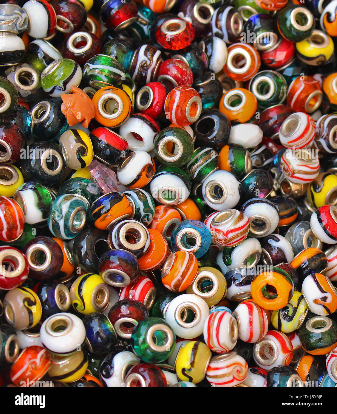 Pile of colorful beads with holes in the middle for making jewelry ...