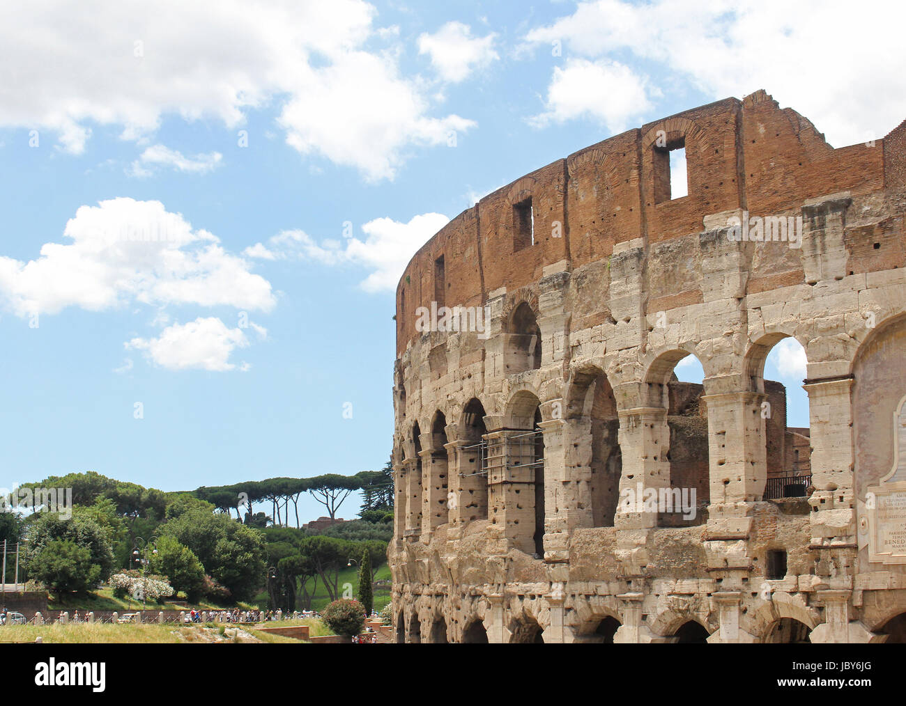 Detail of famous Italian landmark Roman Colosseum with trees in back ...