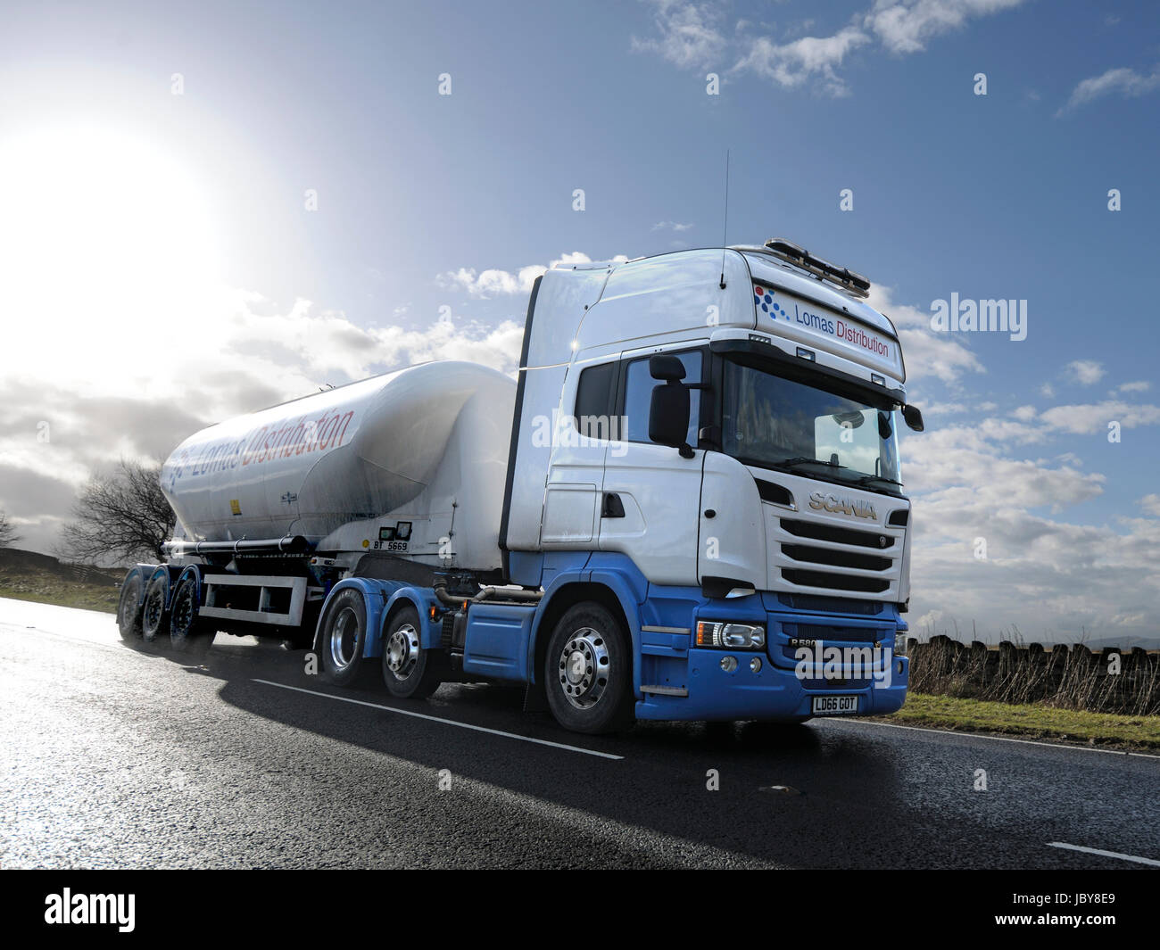 A Lomas Group Scania cement tanker drives along a Derbyshire B-road in ...
