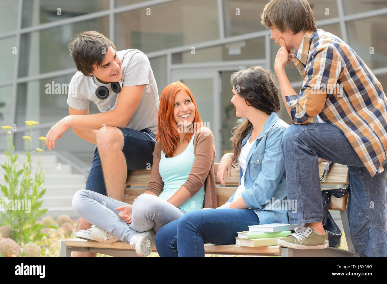 Group of student friends sitting bench outside college hanging out ...