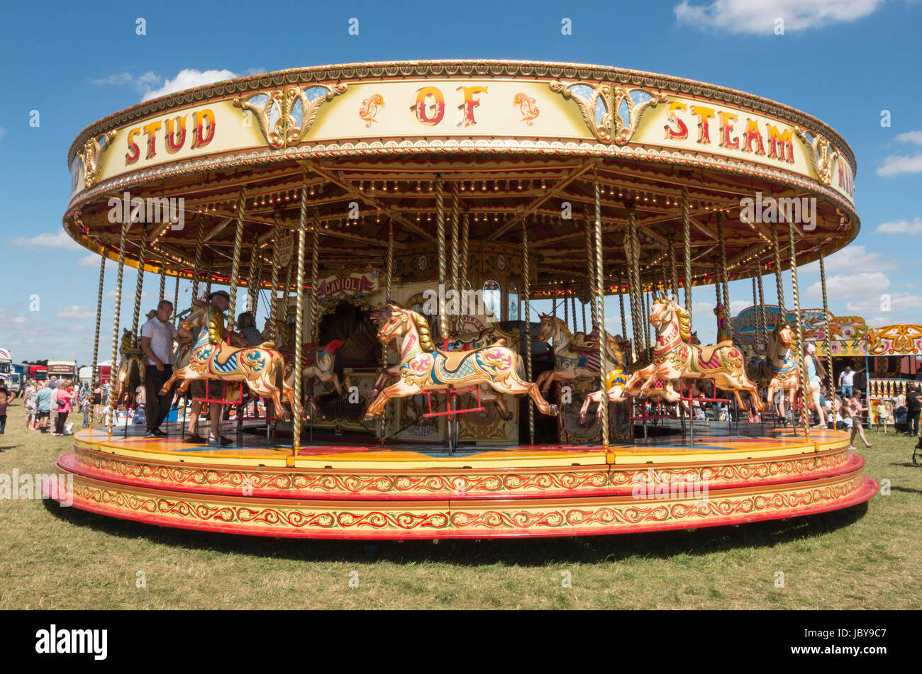 Colourful artistic signwritten vintage Merry-go-round ride with wooden ...