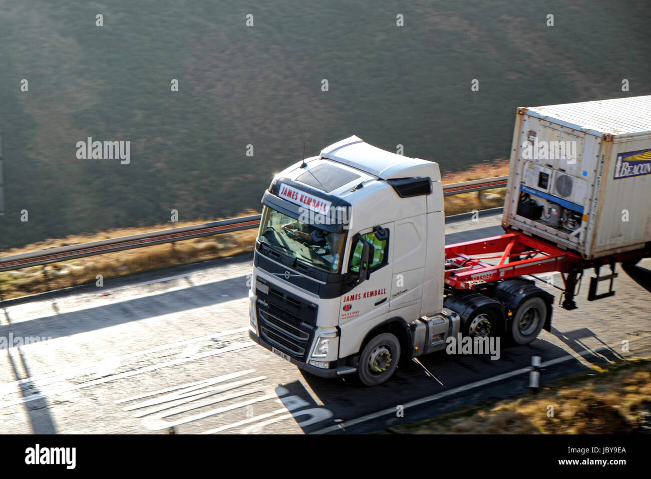 Volvo truck pulling a container trailer climbs the Woodhead PAss on the ...
