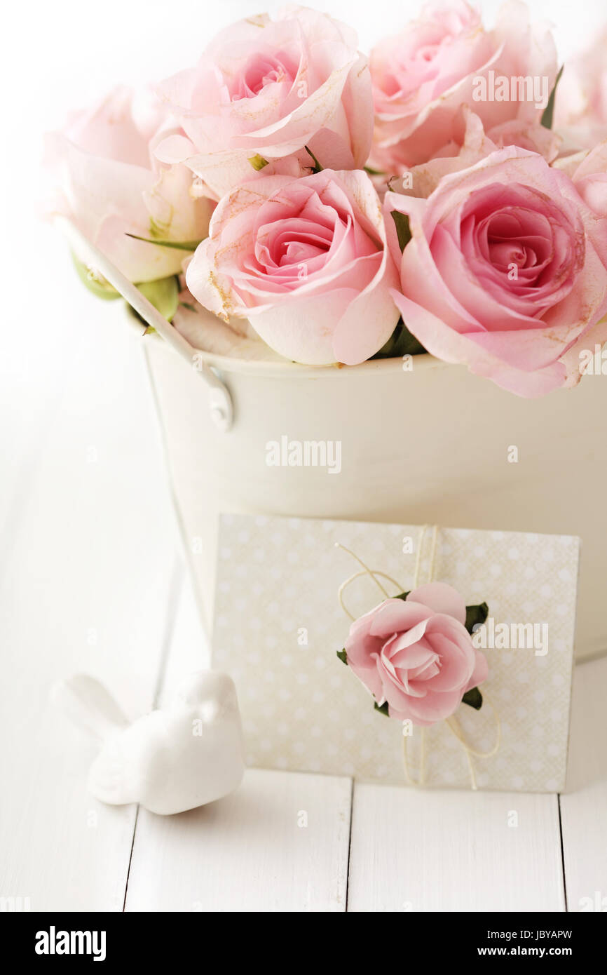 pink rose flowers in a vase and love letter, gift tag, greeting card or ...