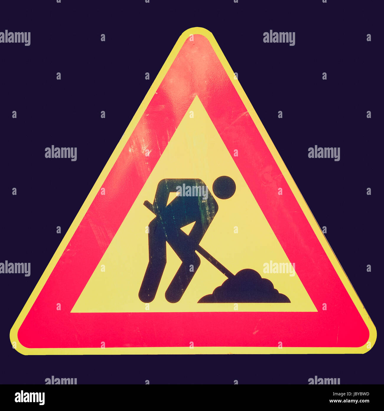 Vintage retro looking Road work sign isolated over a black background ...