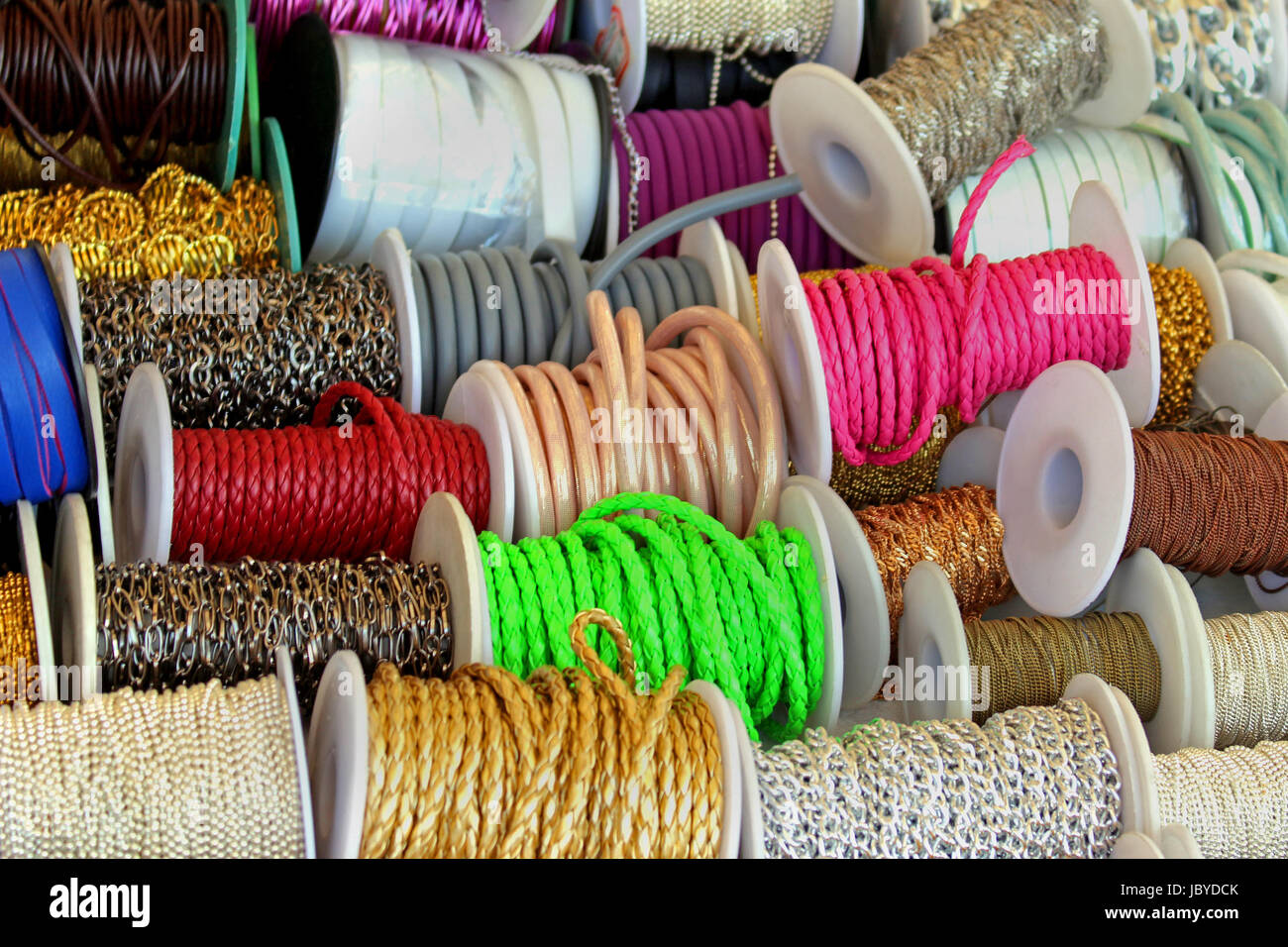 Large pile of colorful ropes on plastic spools Stock Photo - Alamy