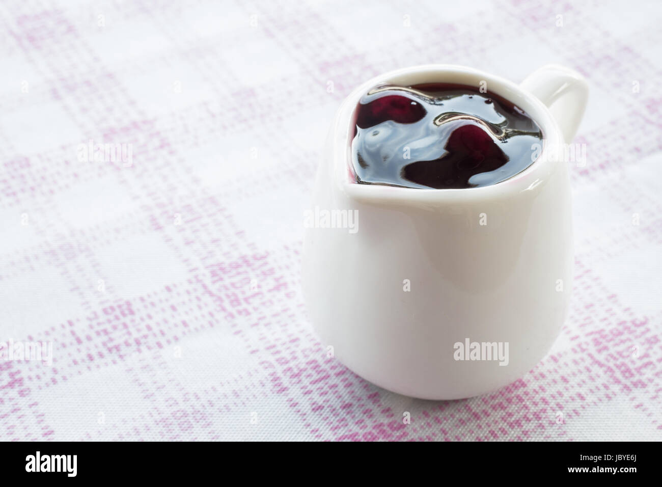 Ceramic pitcher of blueberry sauce, stock photo Stock Photo - Alamy