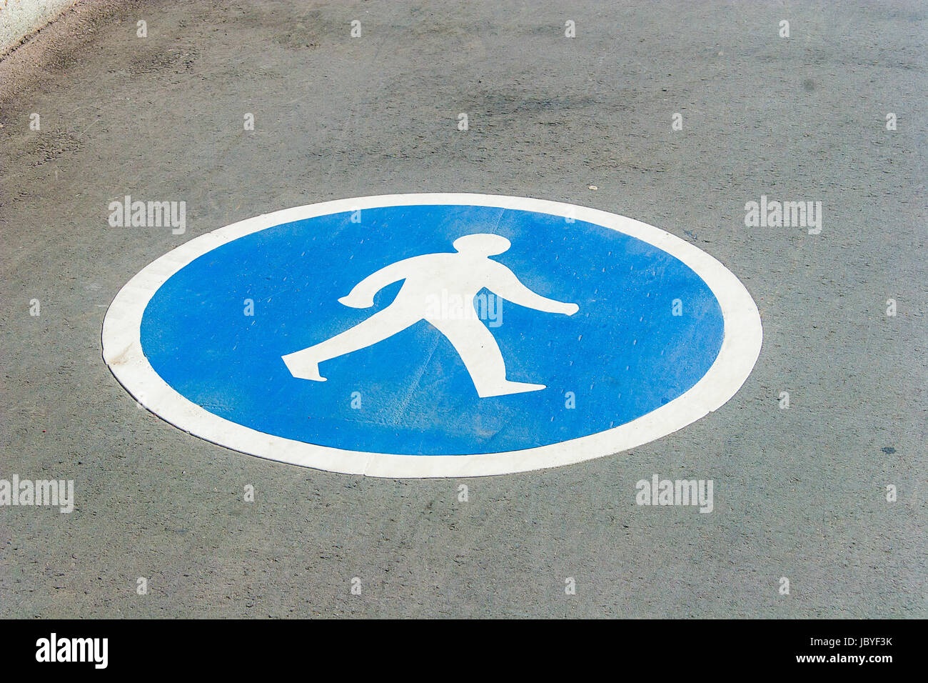Pedestrian lane blue sign on asphalt road Stock Photo - Alamy
