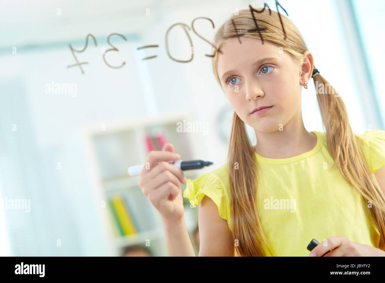 Portrait of lovely girl doing sums on transparent board at lesson Stock ...