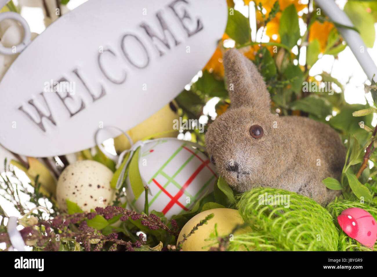 Easter eggs and Easter bunny with welcome sign Stock Photo - Alamy