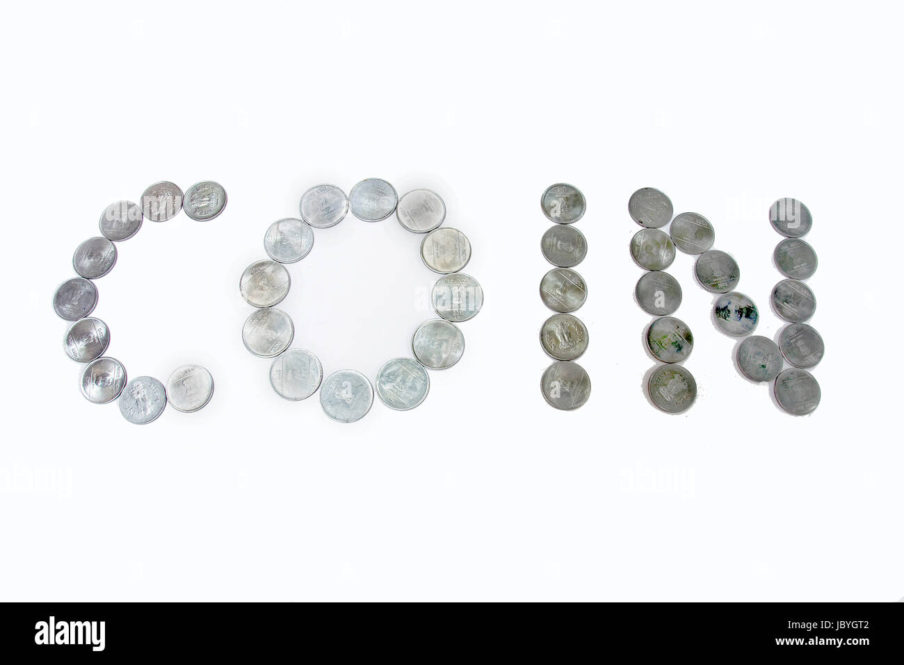 Arrangement of metallic coins to make the word COIN, isolated on white ...