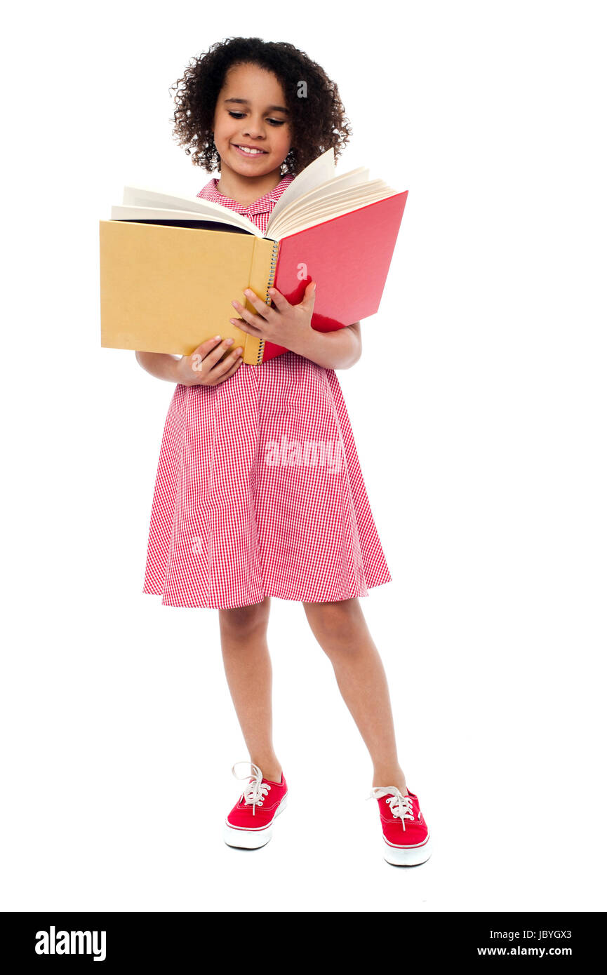School girl in uniform reading a textbook Stock Photo - Alamy
