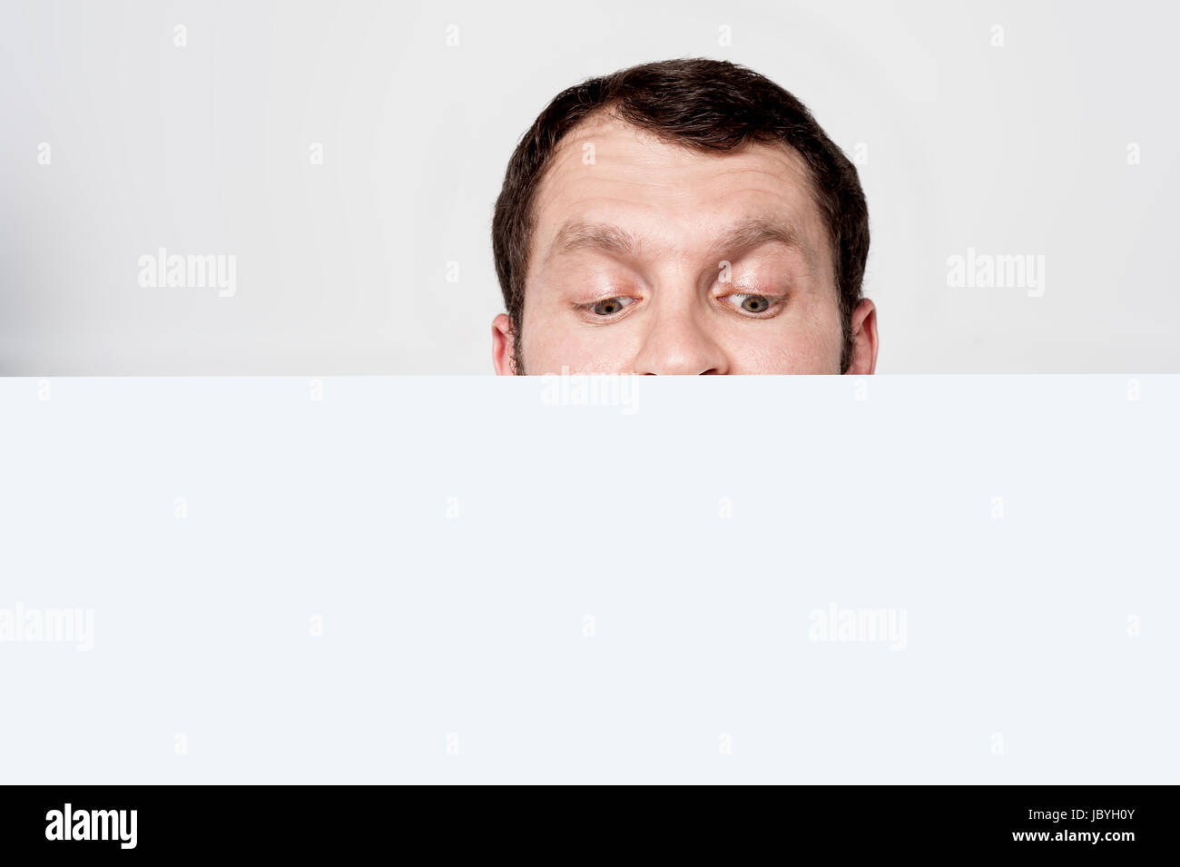 Cropped image a man's face with his eyes looking down Stock Photo - Alamy