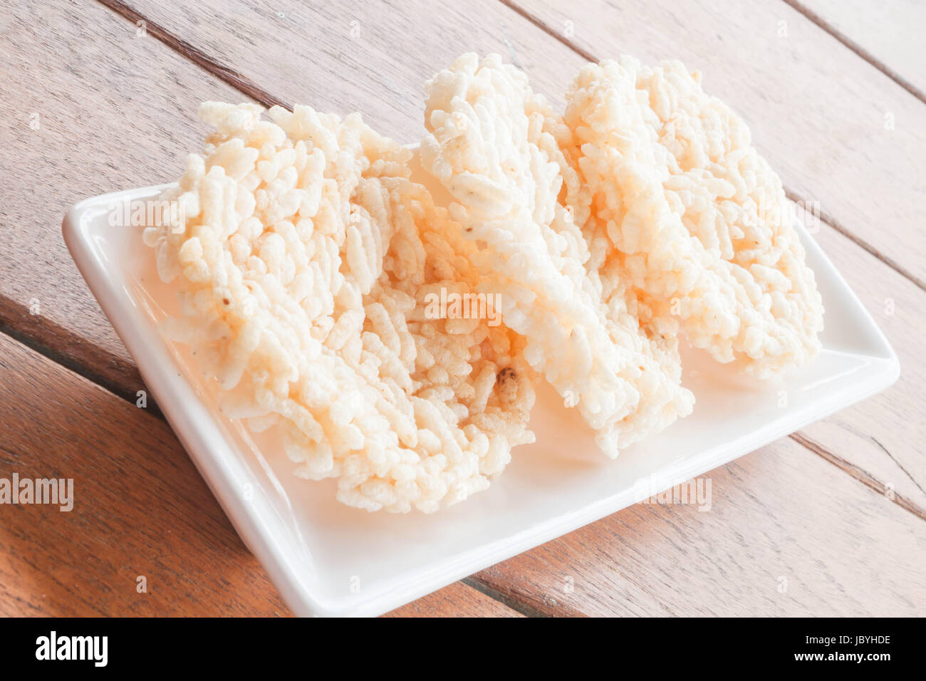 Thai salty crispy rice cracker on white plate Stock Photo - Alamy