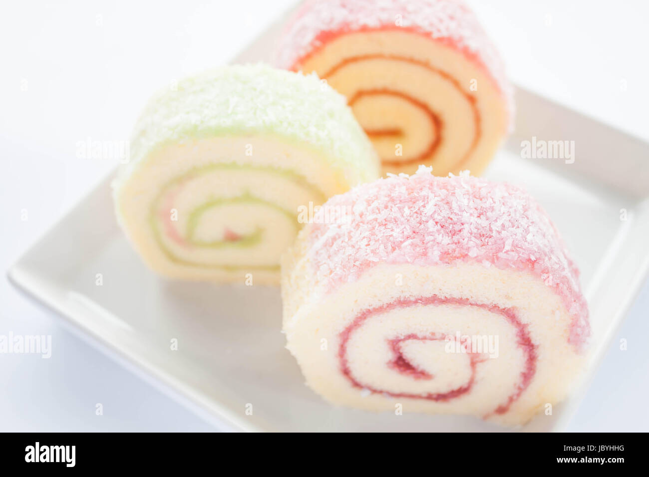 Colorful jam roll cakes on white background , stock photo Stock Photo ...