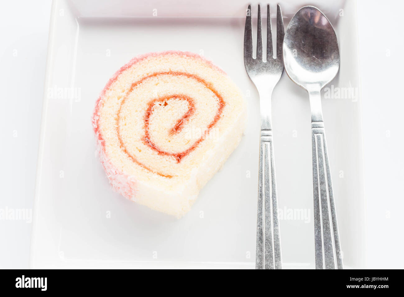 Strawberry jam lamington roll cake with spoon and fork, stock photo ...