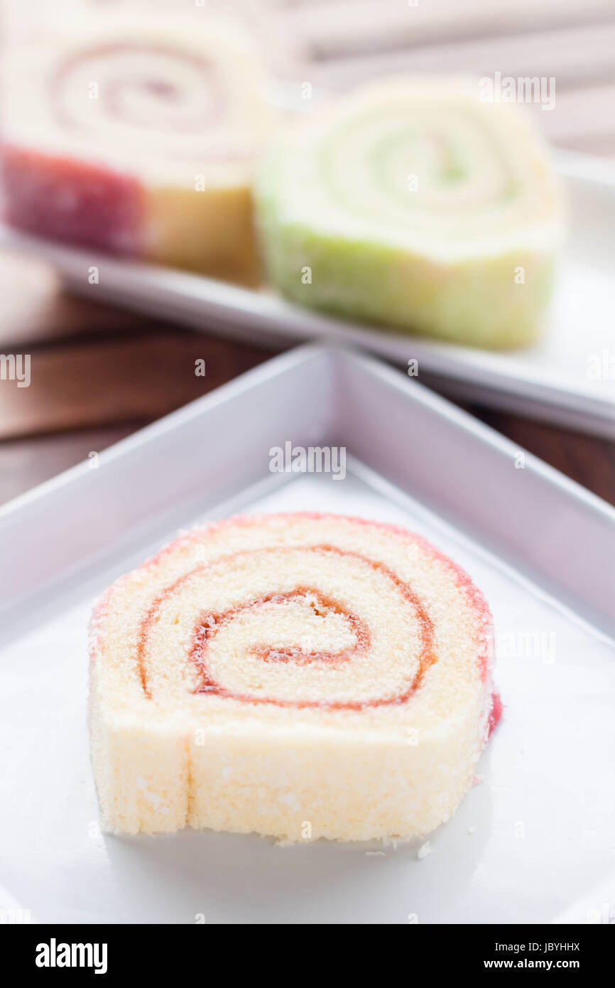 Colorful jam rolls served on wood table, stock photo Stock Photo - Alamy