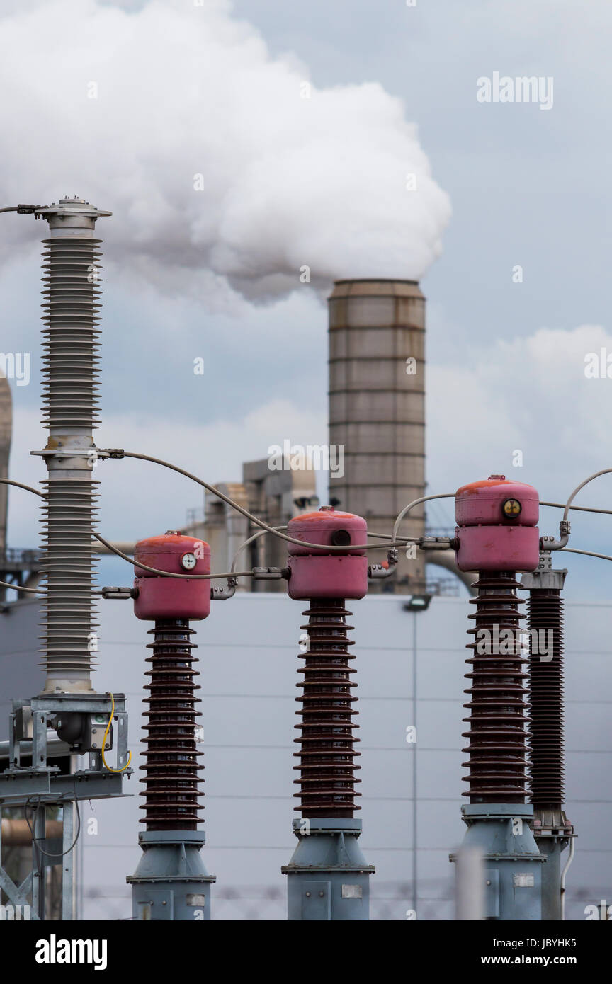 electrical insulators with the background of smoking chimney Stock ...