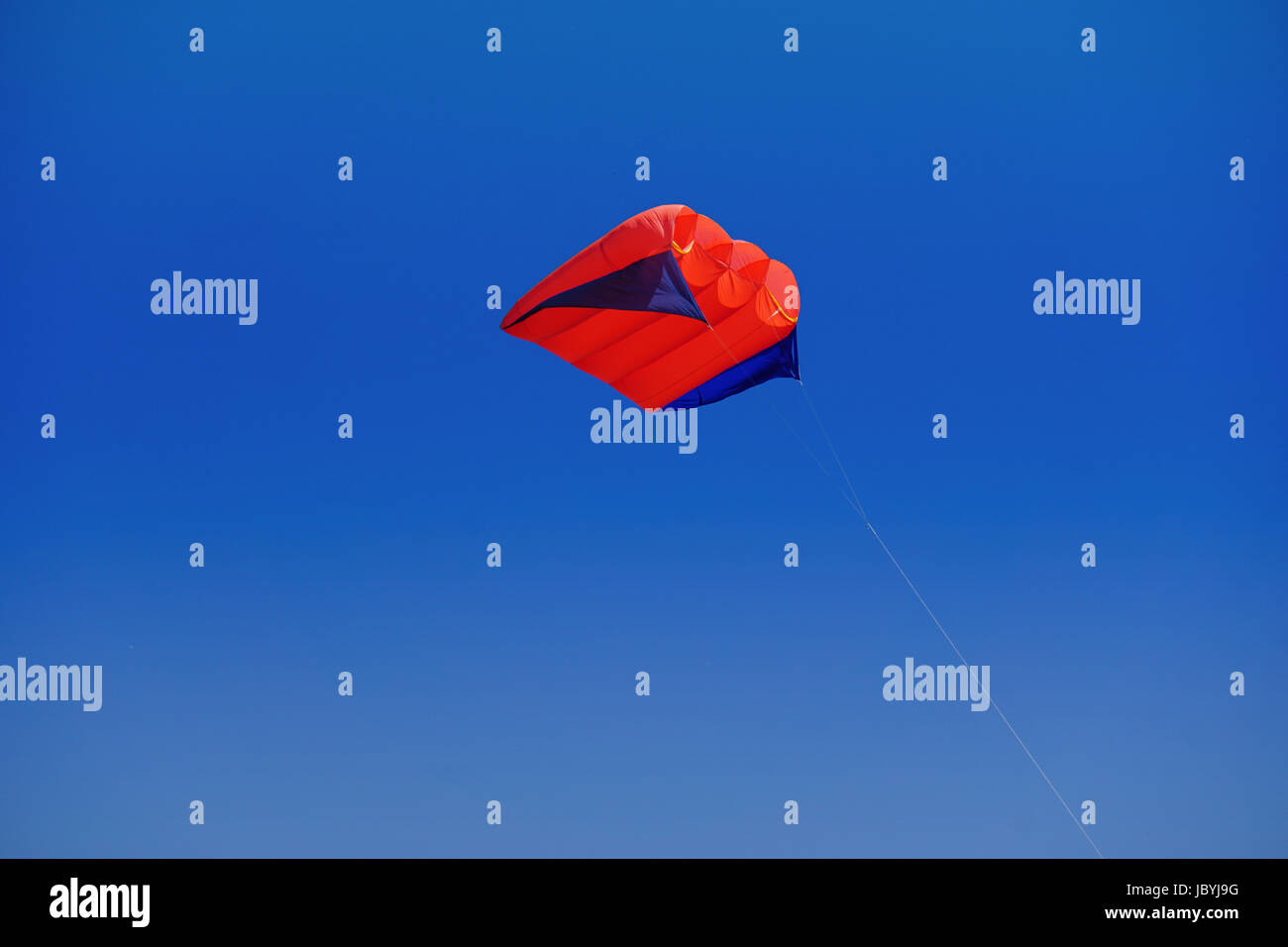 colorful kite flying in the blue sky Stock Photo - Alamy