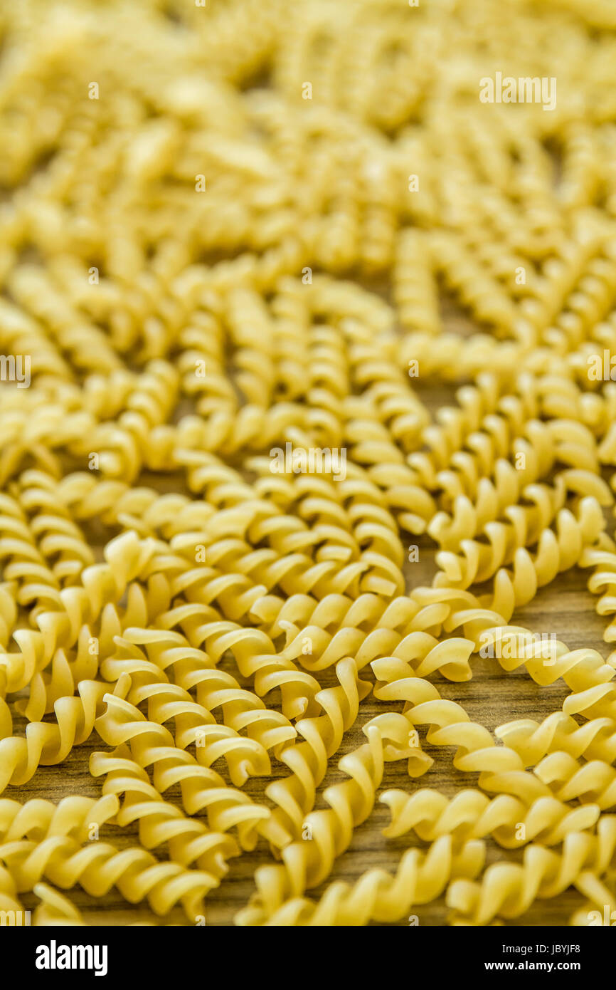 Italian dry pasta covers all over the wooden table Stock Photo - Alamy