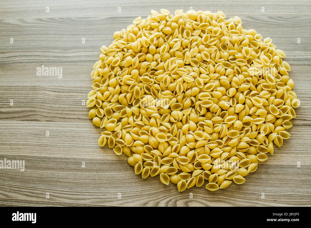 Italian dry pasta covers all over the wooden table Stock Photo - Alamy