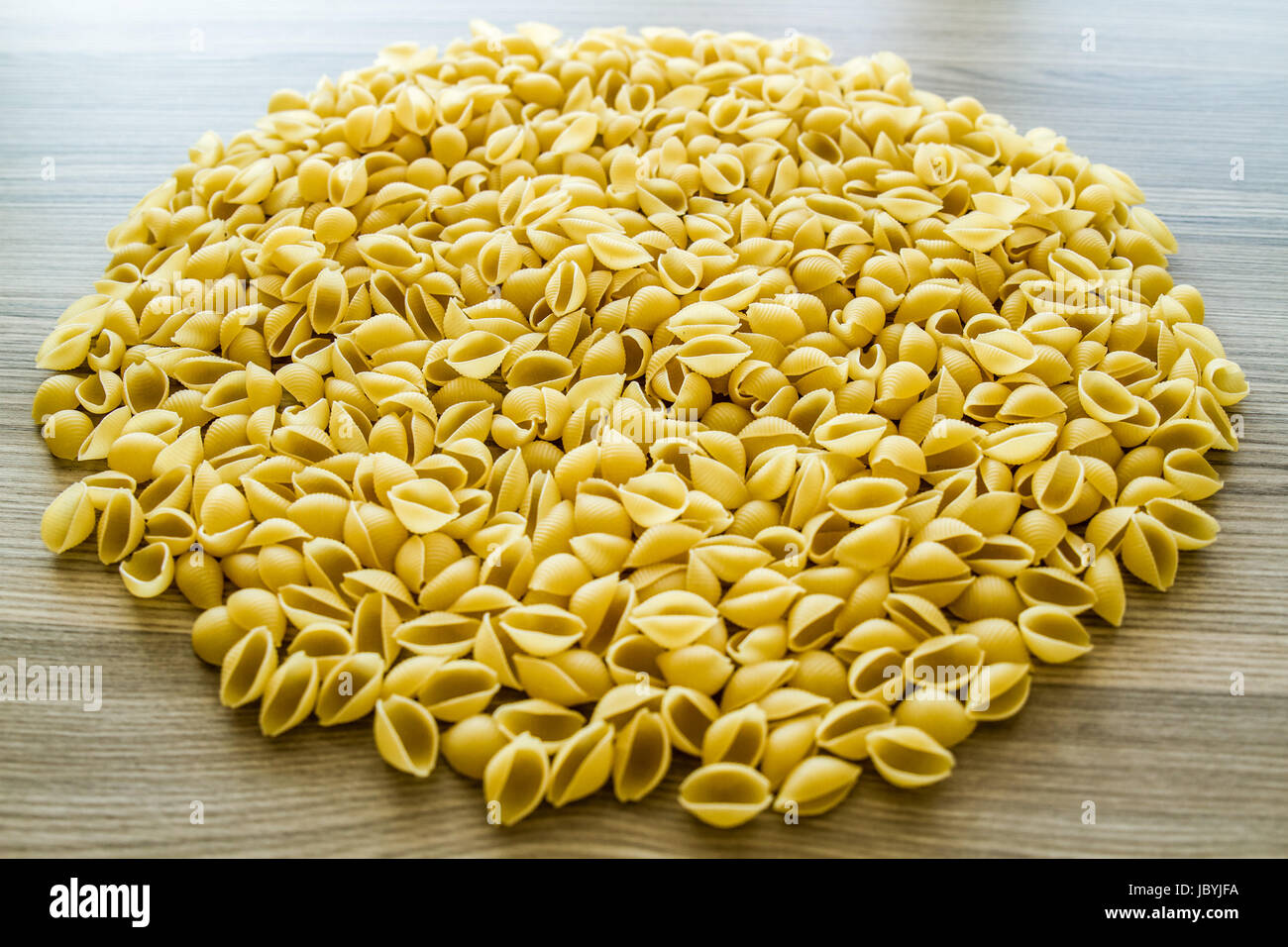 Italian dry pasta covers all over the wooden table Stock Photo - Alamy