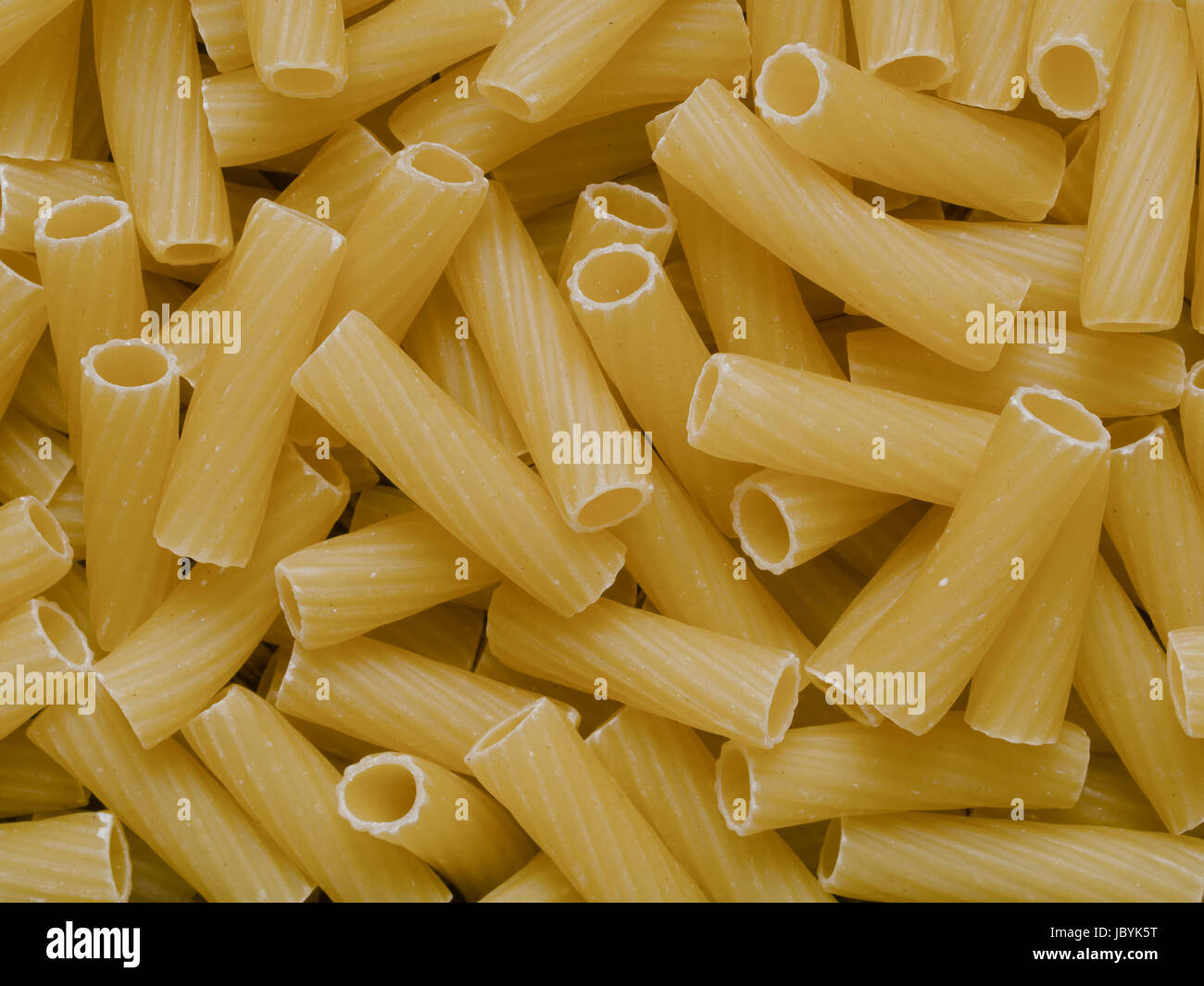 close up of raw uncooked maccheroni pasta tubes food texture background ...