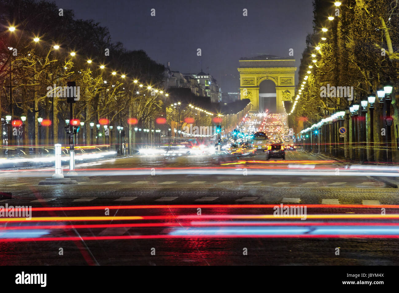 Traffic light trails by arc de triomphe at night hi-res stock ...