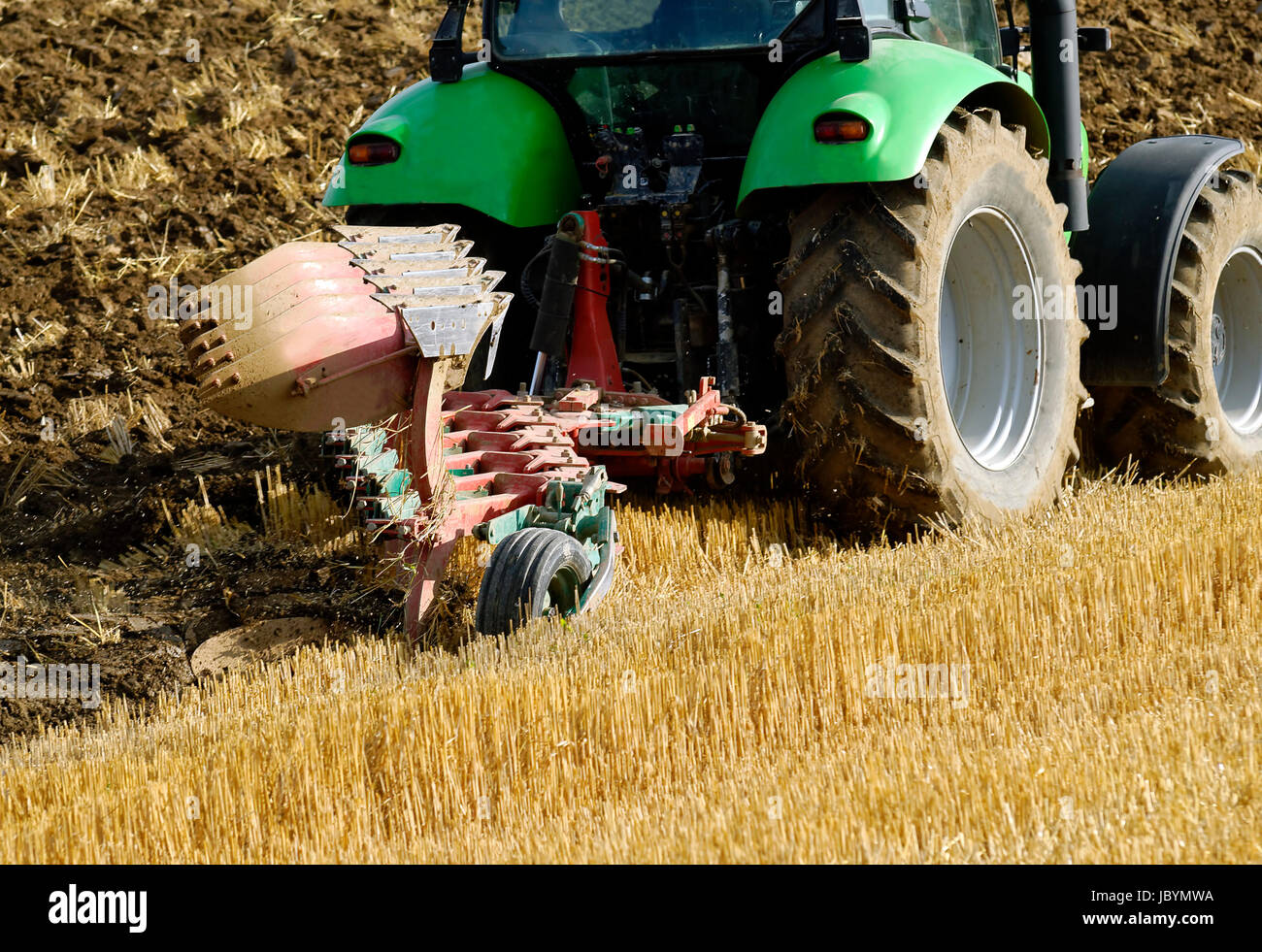 tractor plowing field Stock Photo - Alamy